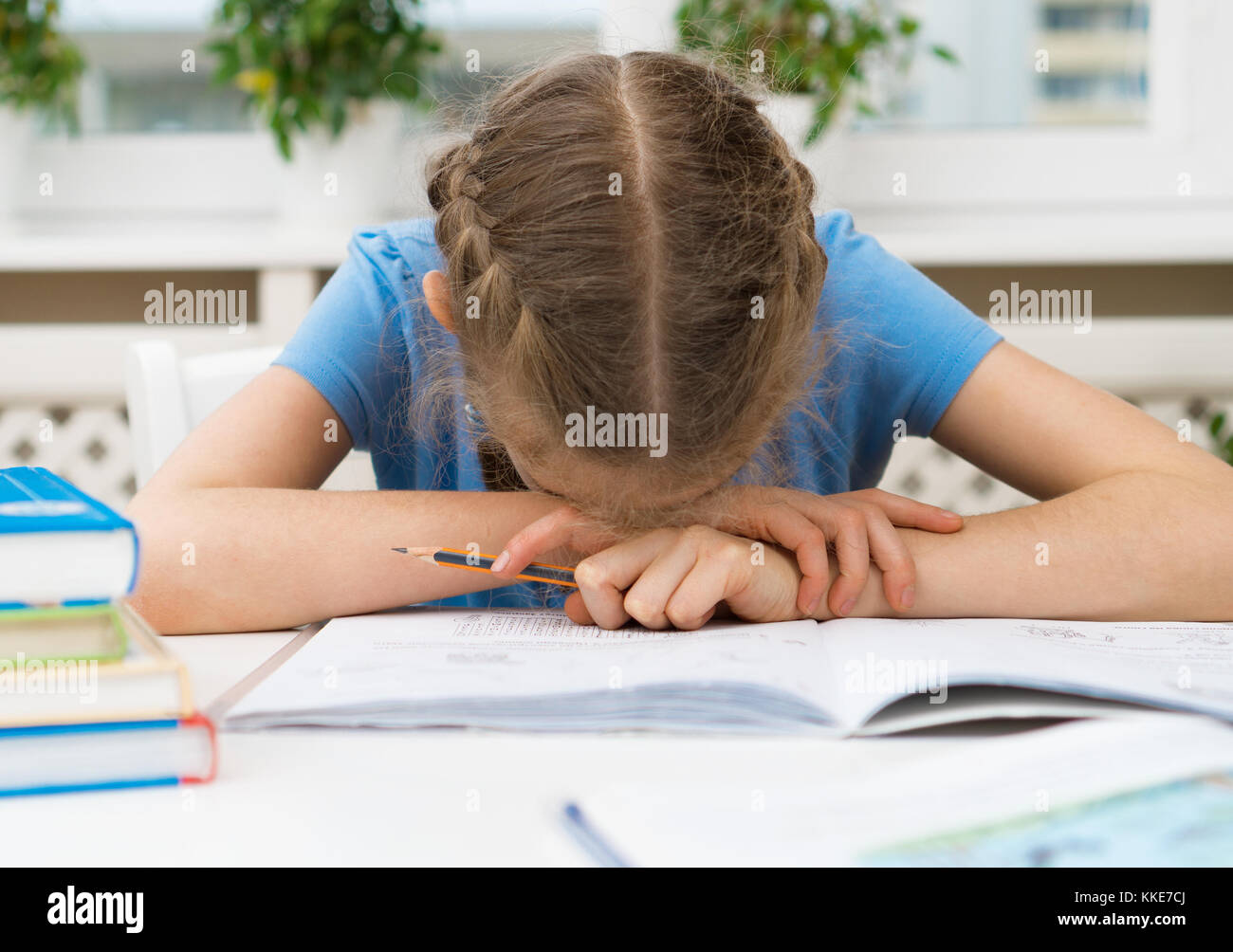Little girl don't want to do her homework Stock Photo - Alamy