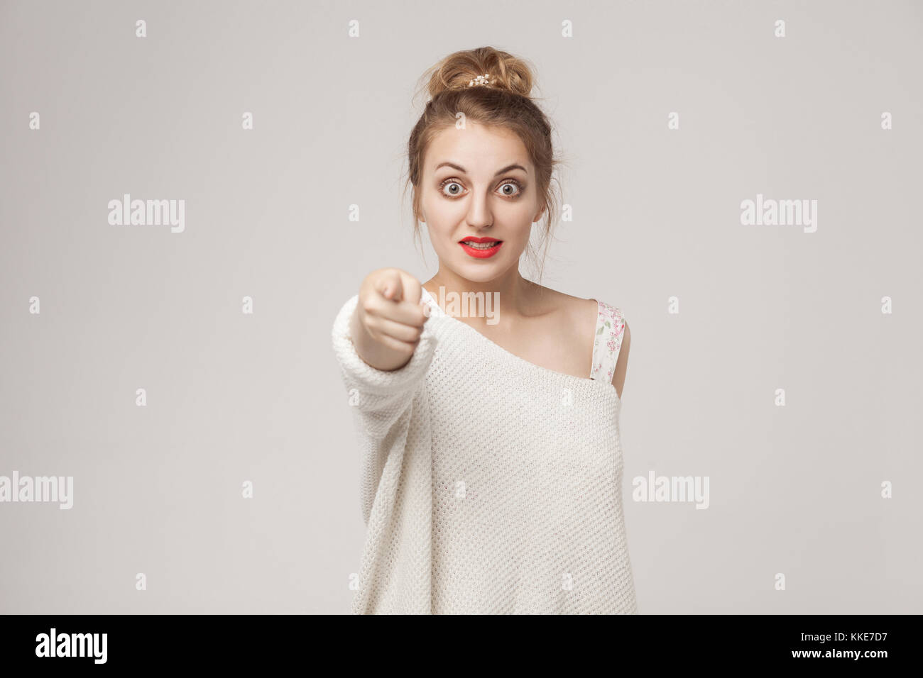 Wow, no way! Surprised woman pointing finger at camera and shocked ...