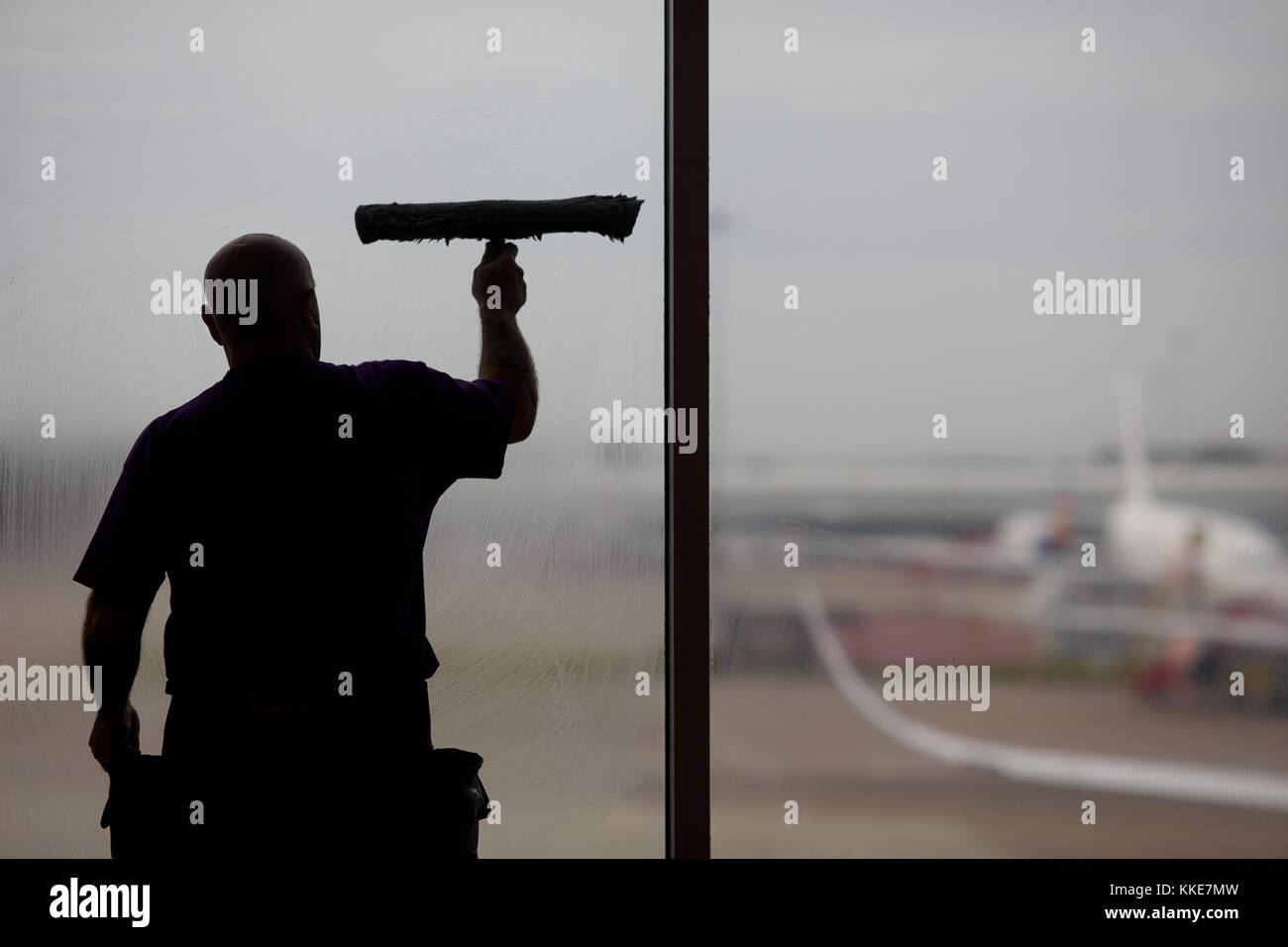 Window cleaner washing the windows at Manchester Airport Terminal two ...