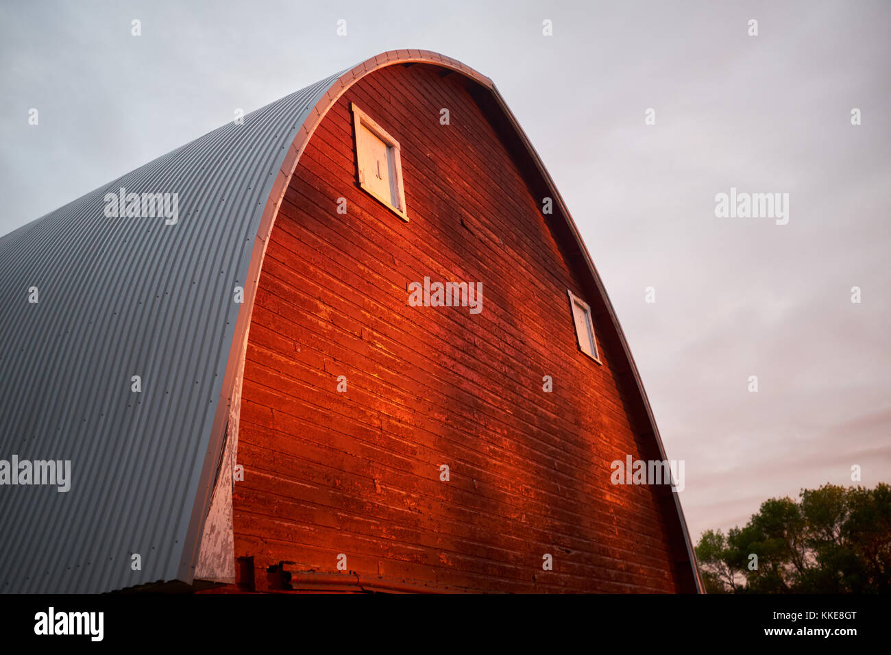 Red timber agricultural barn, North Dakota with a traditional arched or ...
