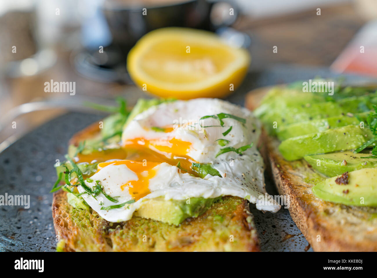 Breakfast served and started poached egg with yoke running onto sliced ...
