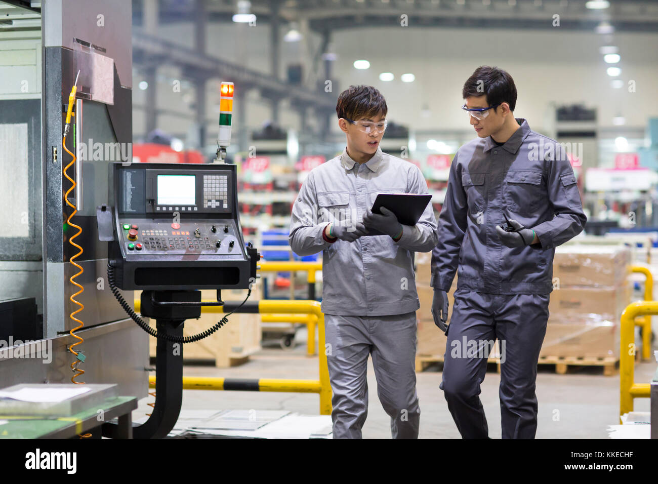 Confident Chinese engineers talking in the factory Stock Photo - Alamy