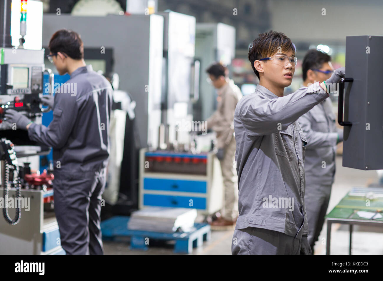 Confident Chinese engineers working in the factory Stock Photo - Alamy