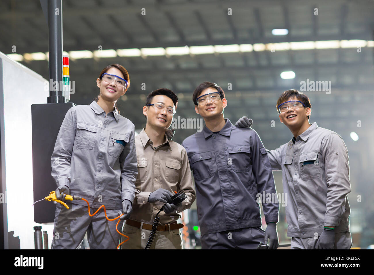 Confident Chinese engineering team in the factory Stock Photo - Alamy