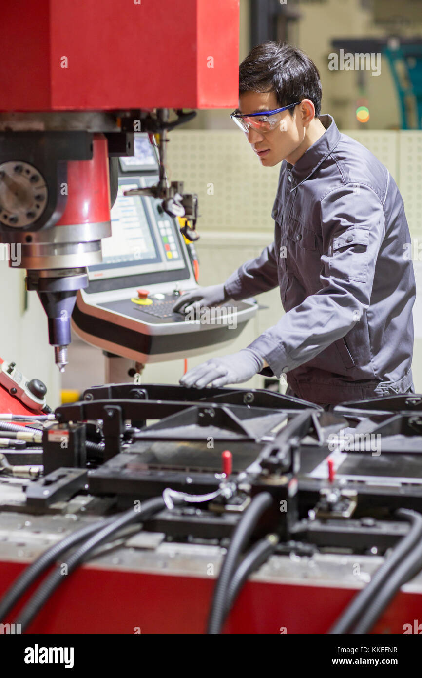 Young Chinese engineer working in the factory Stock Photo - Alamy