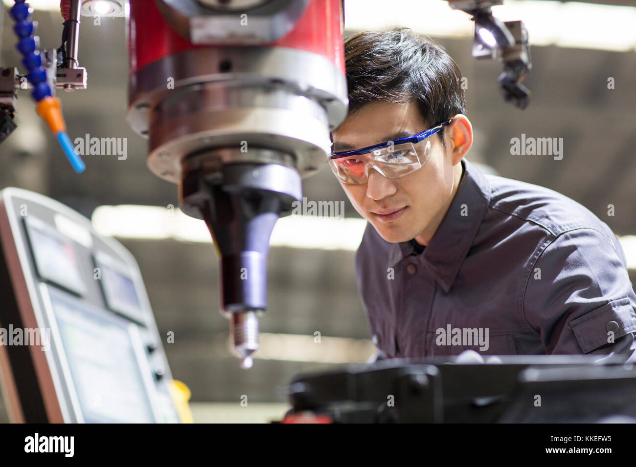 Young Chinese engineer working in the factory Stock Photo - Alamy