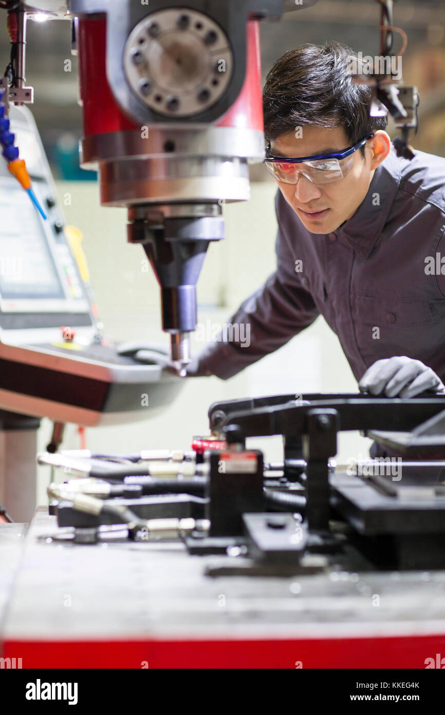 Young Chinese engineer working in the factory Stock Photo - Alamy