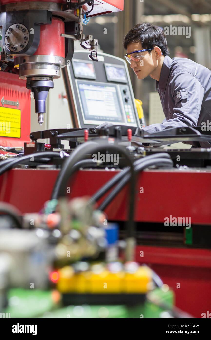 Young Chinese engineer working in the factory Stock Photo - Alamy