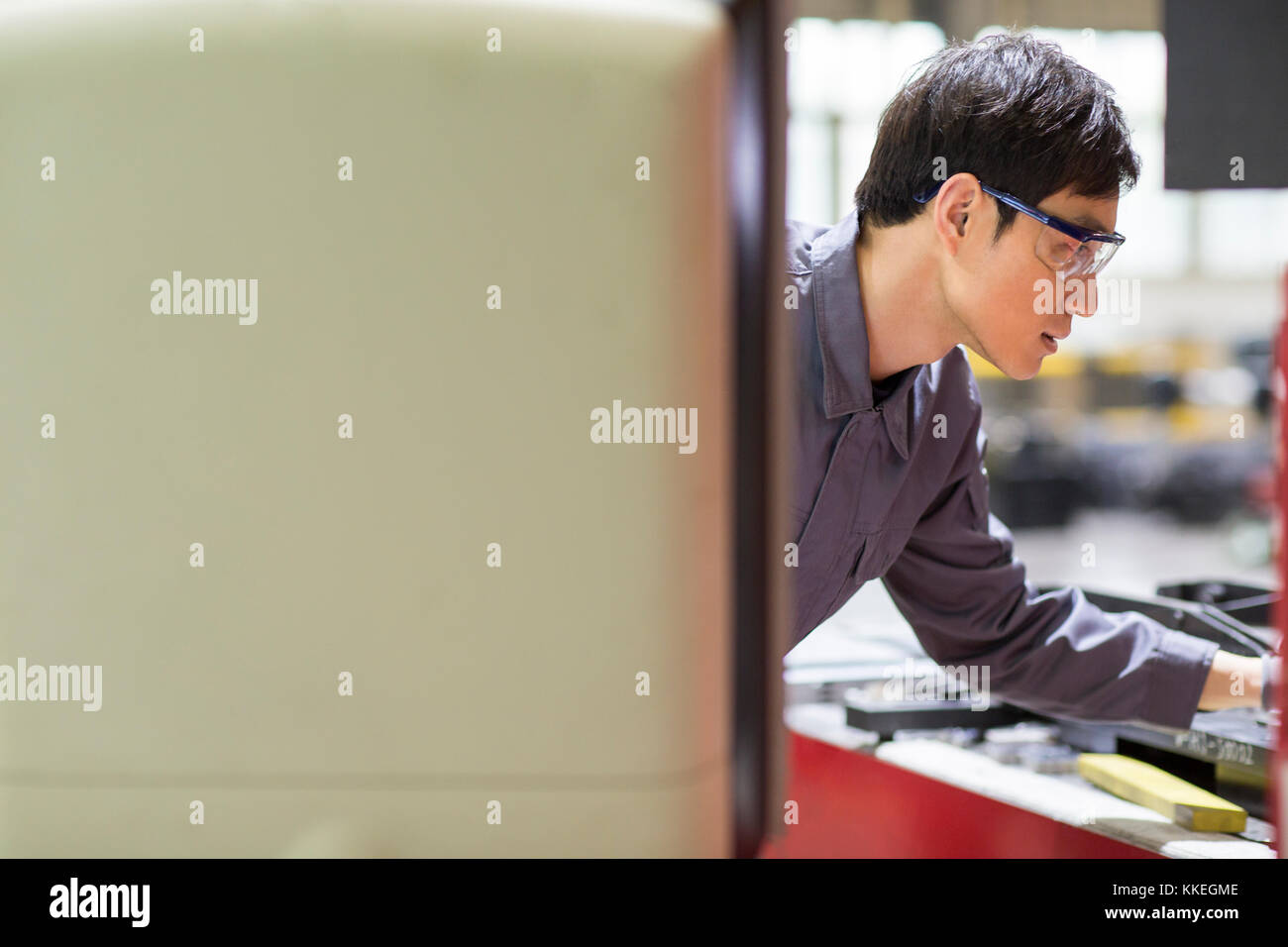 Young Chinese engineer working in the factory Stock Photo - Alamy