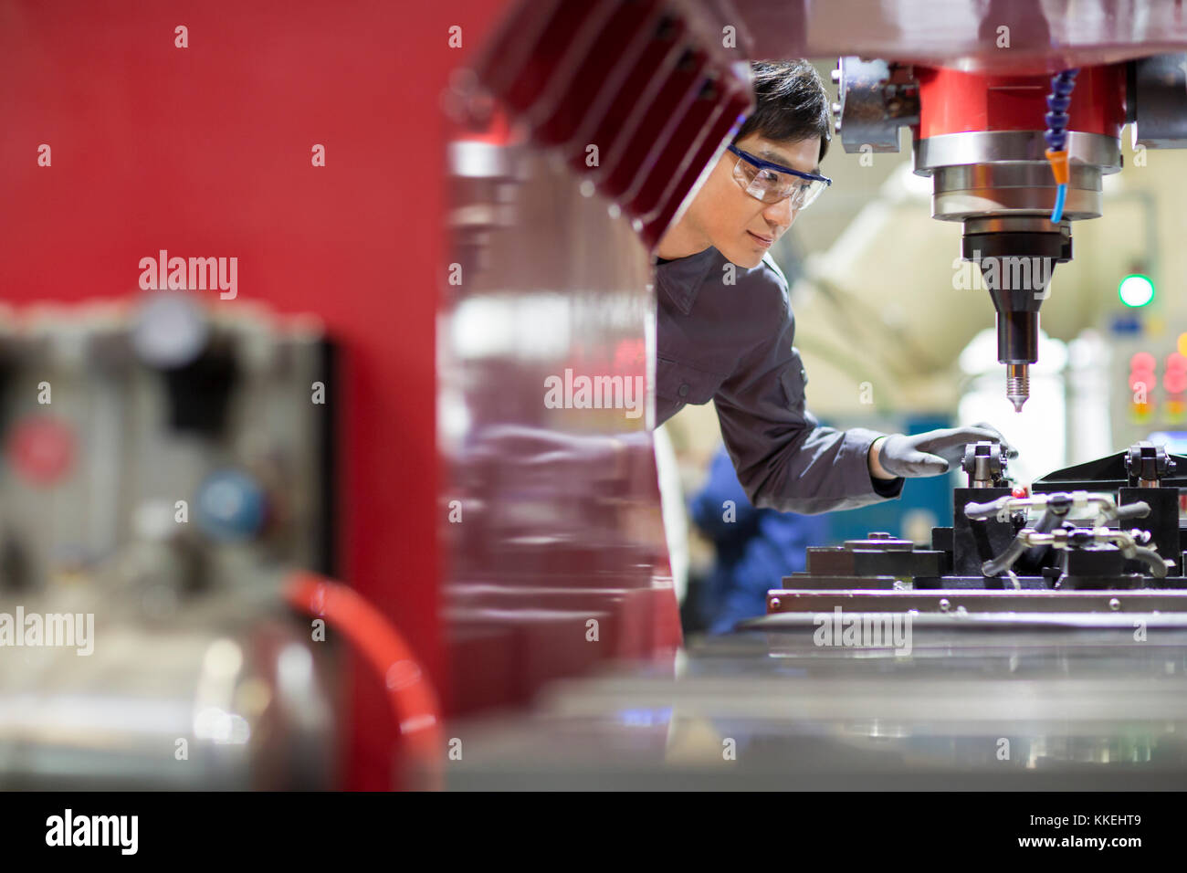 Young Chinese engineer working in the factory Stock Photo - Alamy