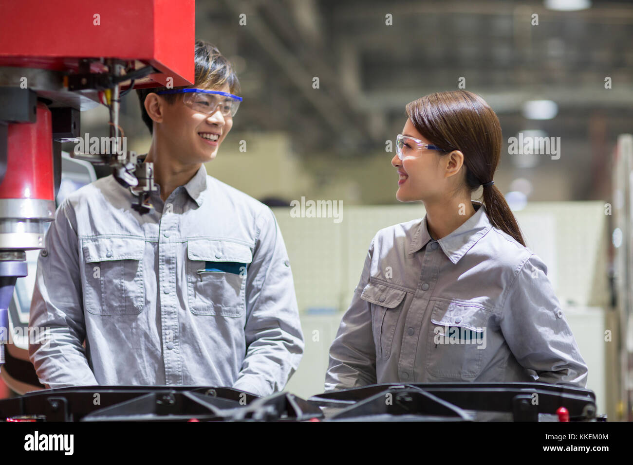Young Chinese engineers talking in the factory Stock Photo - Alamy