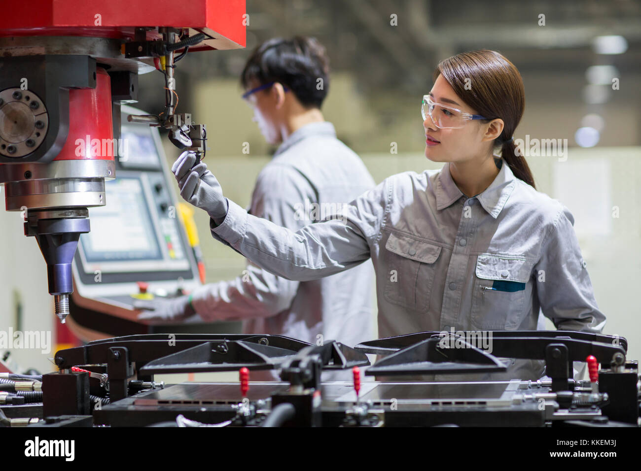 Young Chinese engineers working in the factory Stock Photo - Alamy