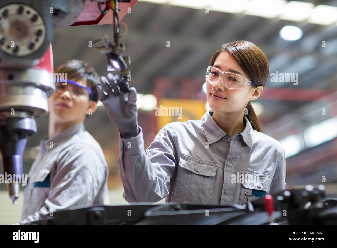 Young Chinese engineers working in the factory Stock Photo - Alamy