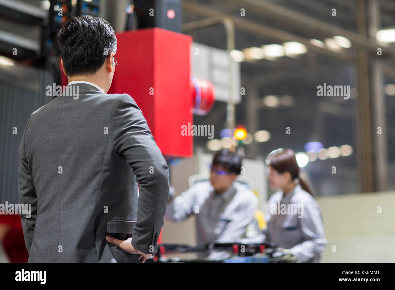 Confident Chinese businessman standing in the factory Stock Photo - Alamy