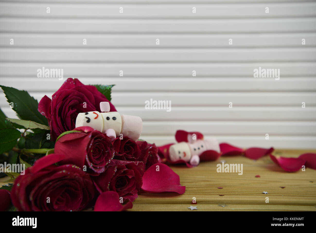 winter season romantic photography image with red rose flower petals ...