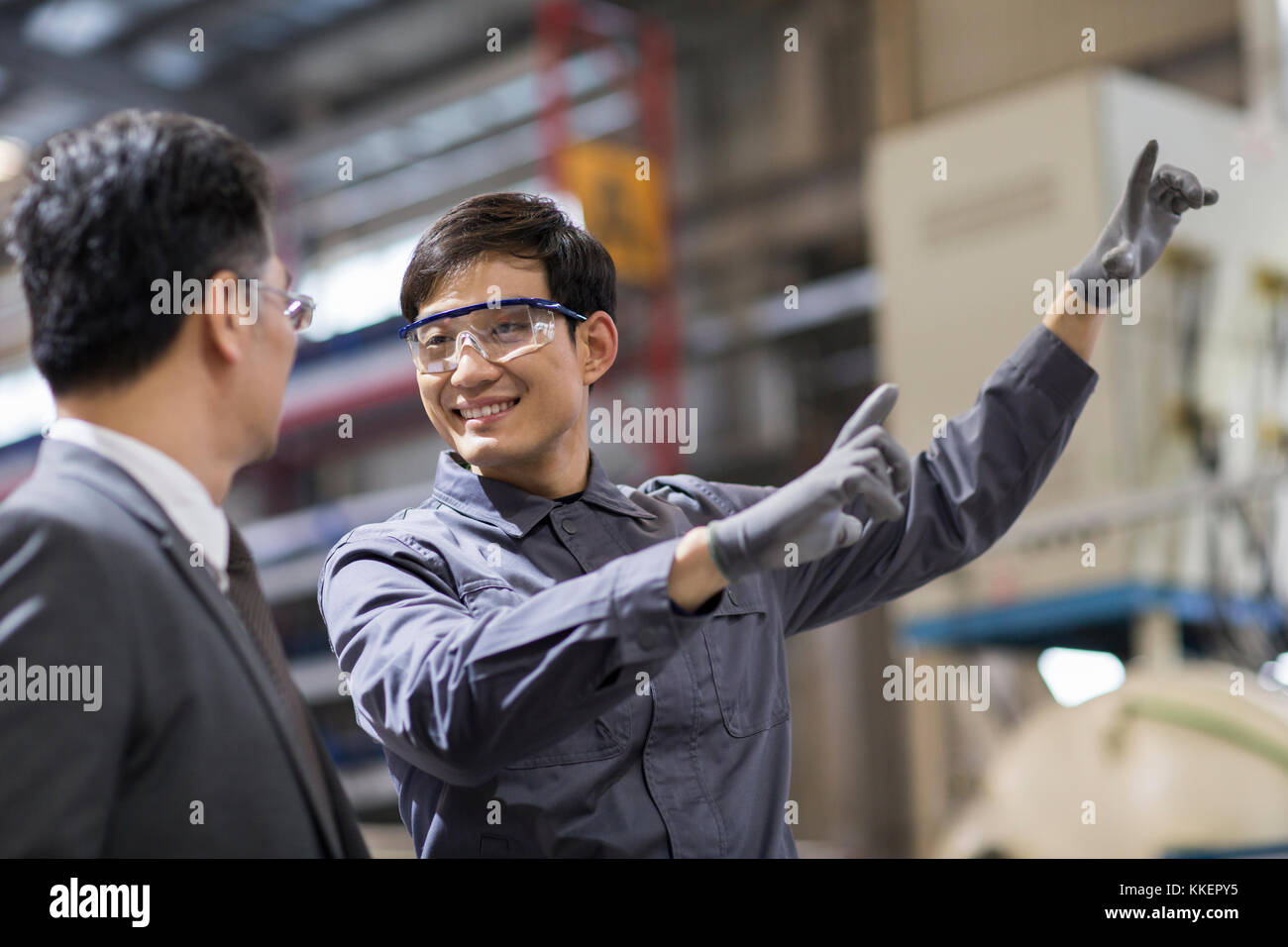 Chinese businessman and engineer talking in the factory Stock Photo - Alamy