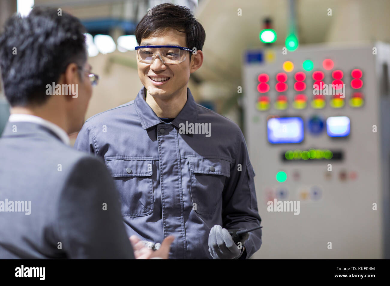 Chinese businessman and engineer talking in the factory Stock Photo - Alamy