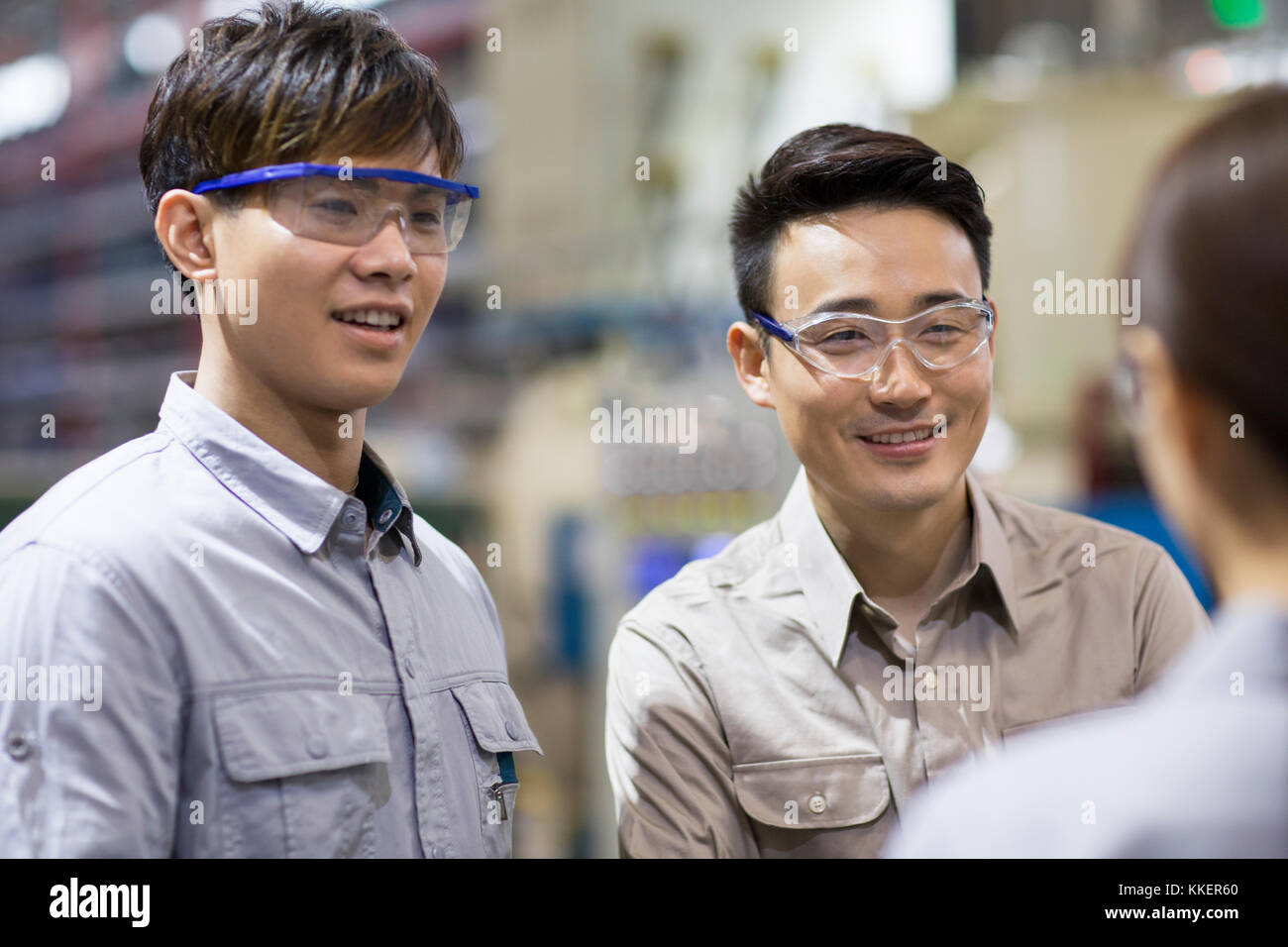 Confident Chinese engineers talking in the factory Stock Photo - Alamy