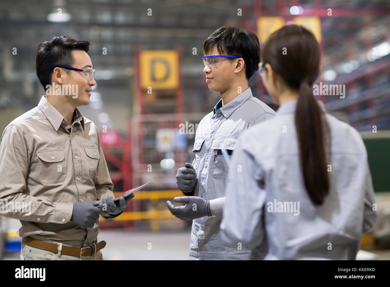 Confident Chinese engineers talking in the factory Stock Photo - Alamy