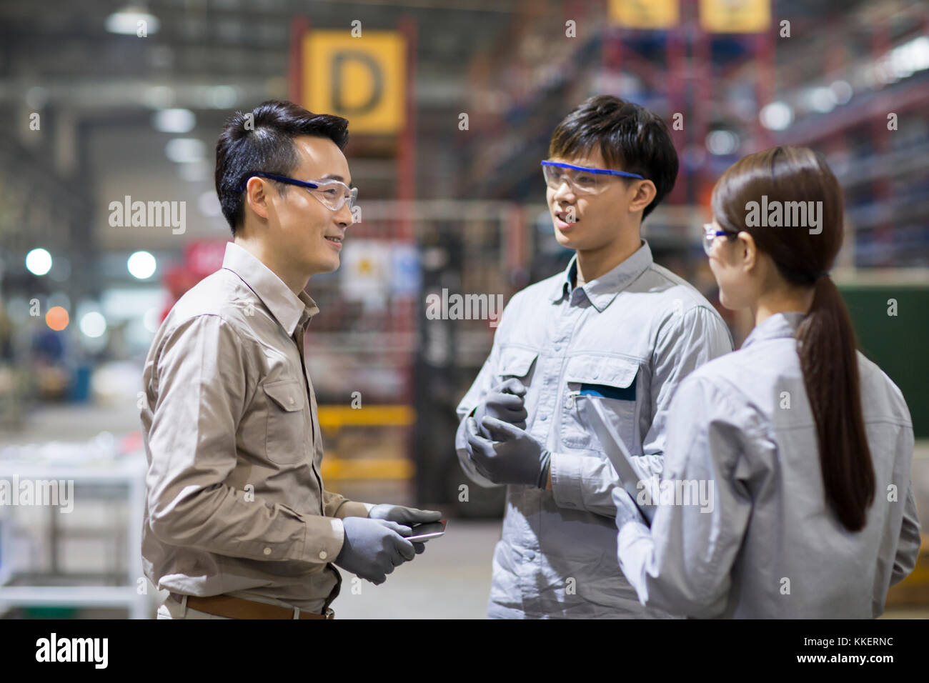 Confident Chinese engineers talking in the factory Stock Photo - Alamy