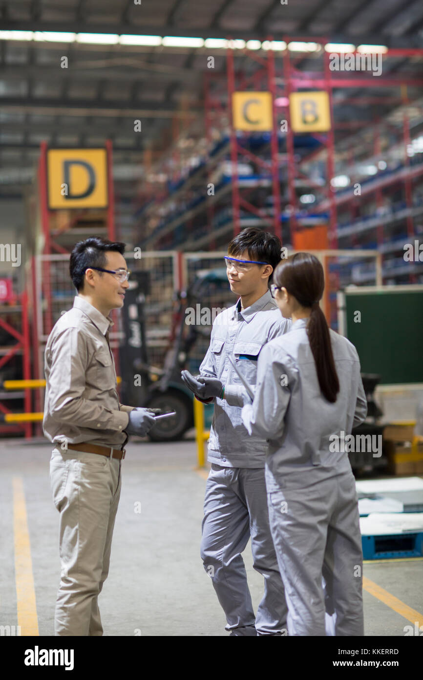 Confident Chinese engineers talking in the factory Stock Photo - Alamy