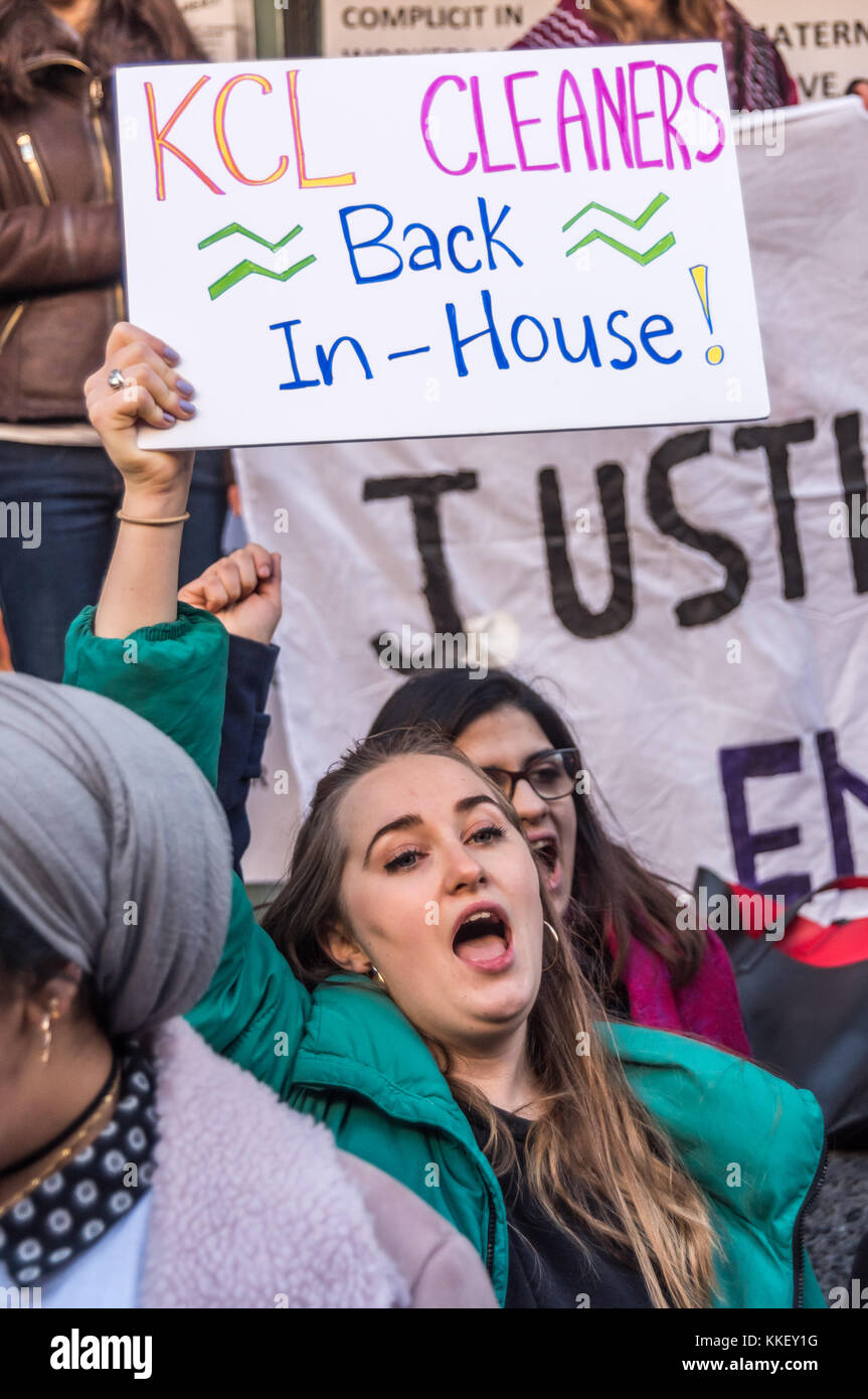 London, UK. 1st December 2015. A woman holds up a poster 'KCL Cleaners ...