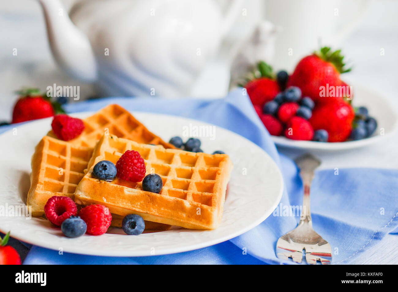 Belgian Waffles With Berries On Rustic Background Stock Photo - Alamy