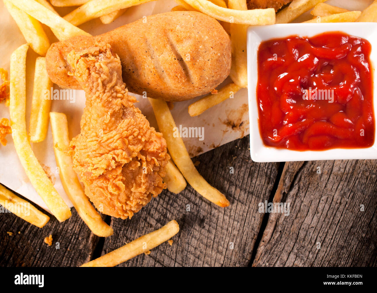 Deep fried chicken leg and french fries from above Stock Photo - Alamy