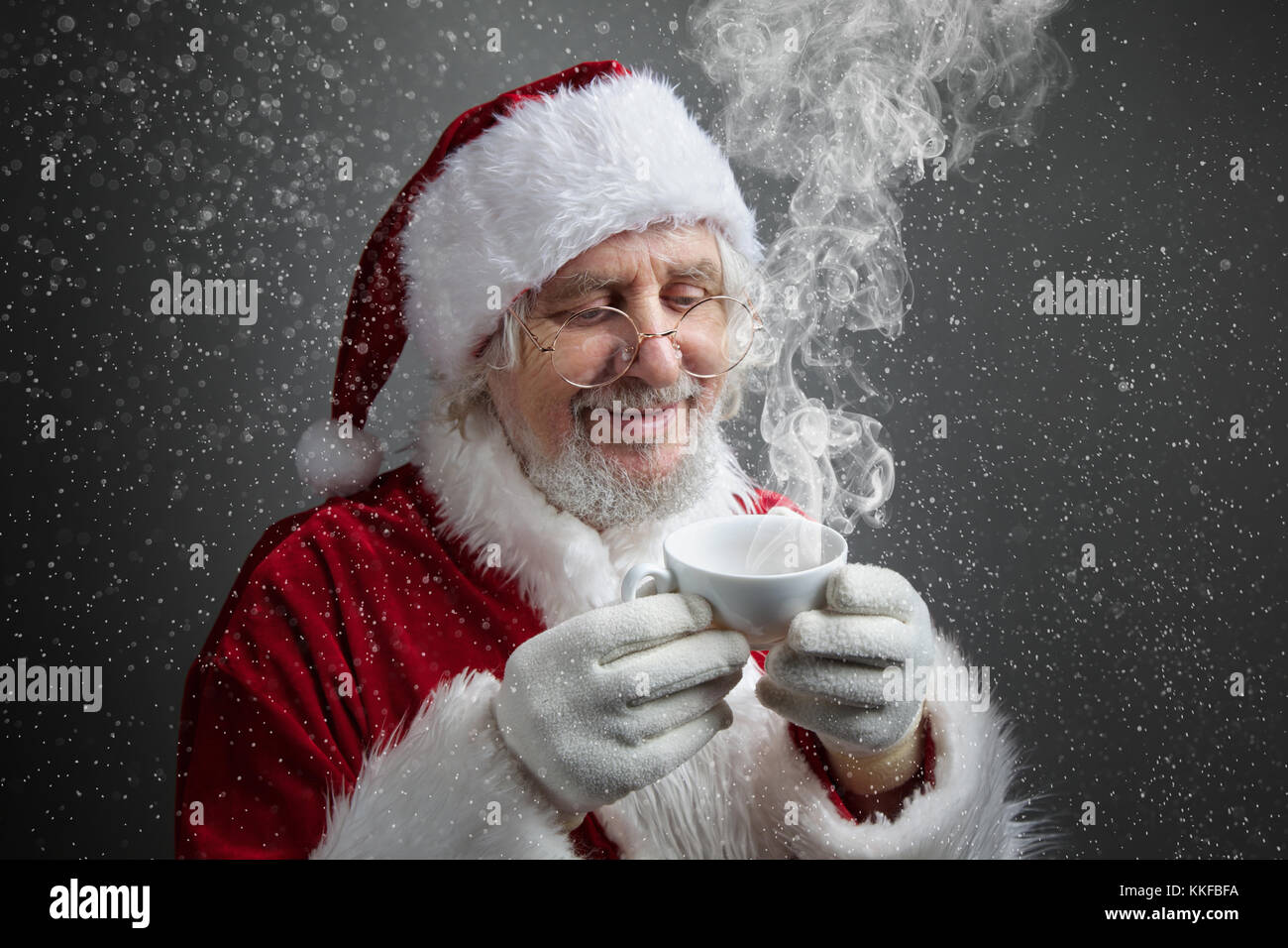 Kind Santa Claus resting wearing red costume blowing on cup of hot ...
