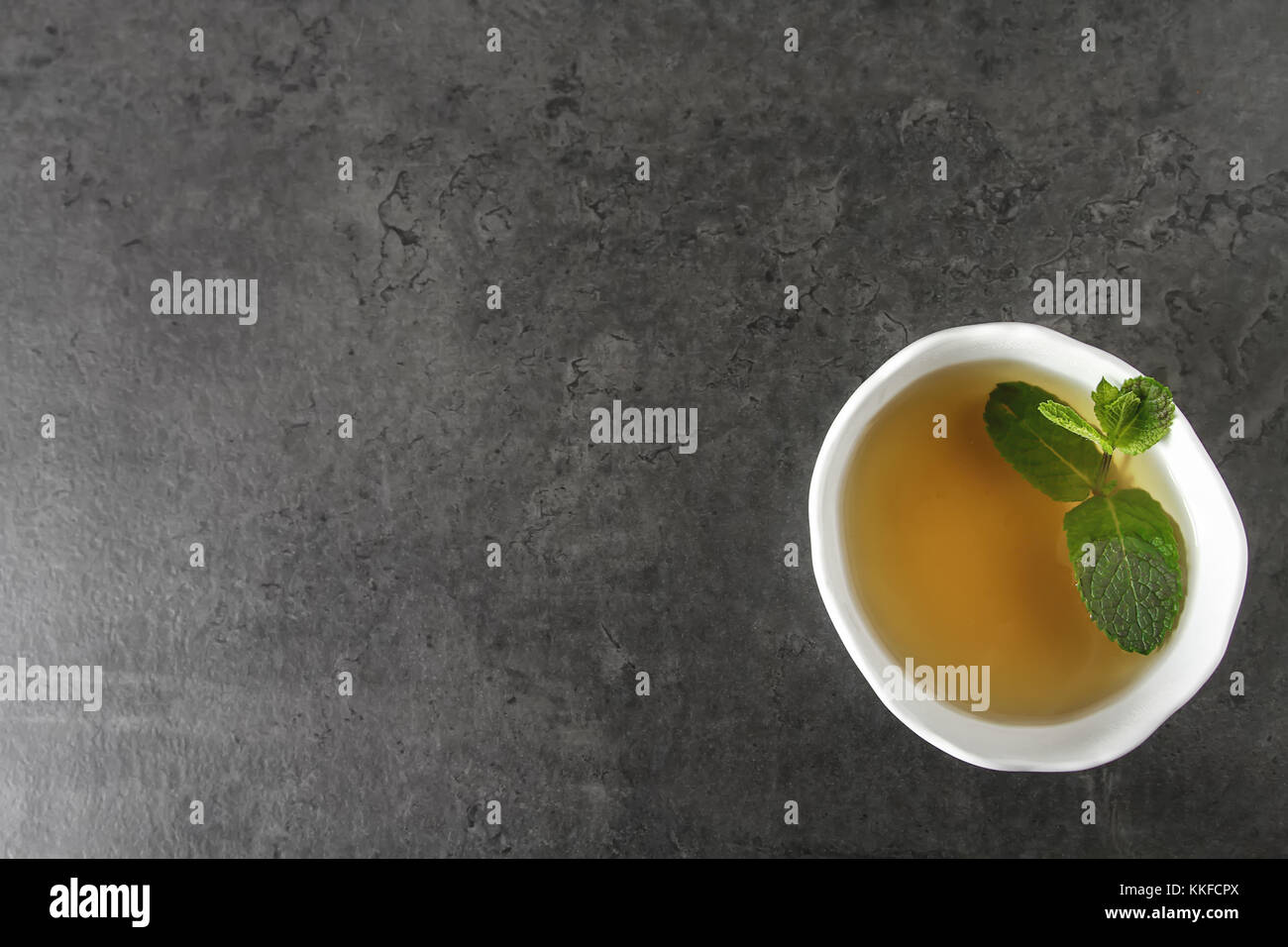 Fresh mint leaves in tea. Italian herbs. Dark background Stock Photo ...