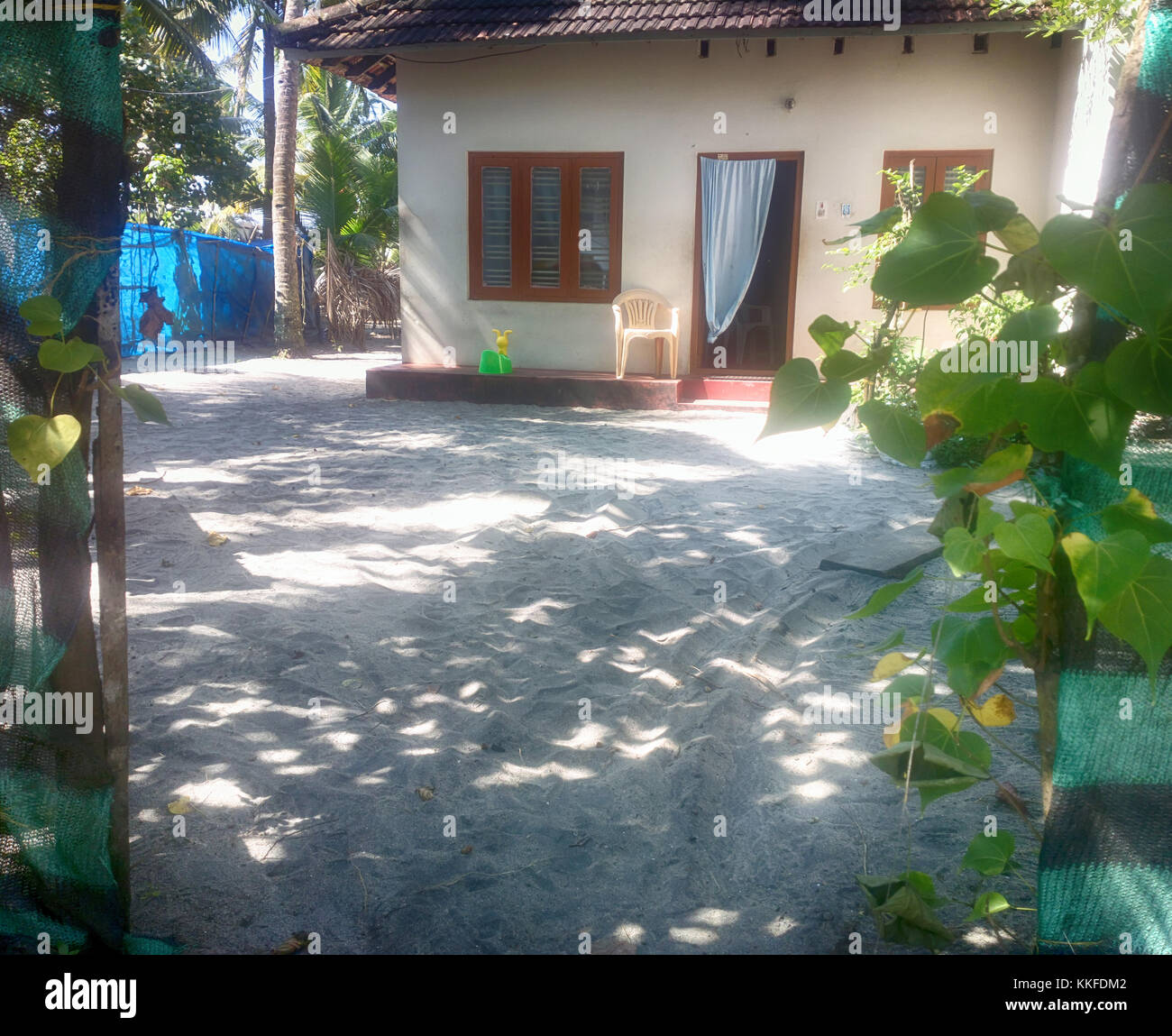 Indian house on shore of Arabian sea. Yard is stretch of beach. Kerala ...