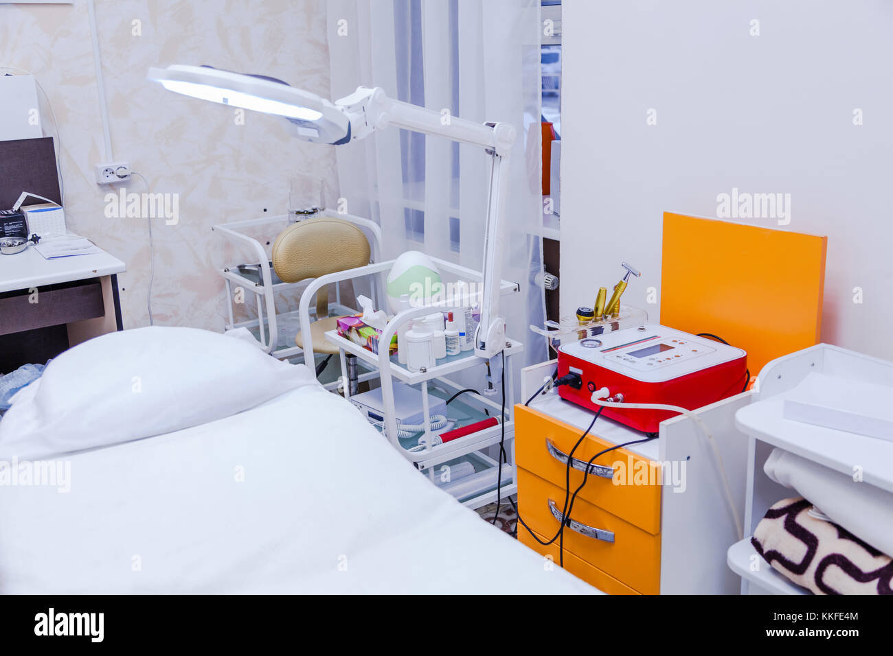 Bright interior of the cosmetology room with equipment, lamps and ...