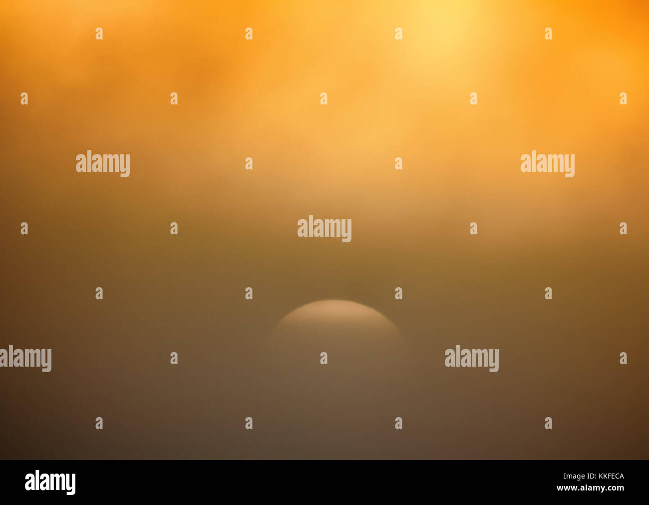 The setting sun in the misty haze. Yellow summer sunset promises Sunny ...