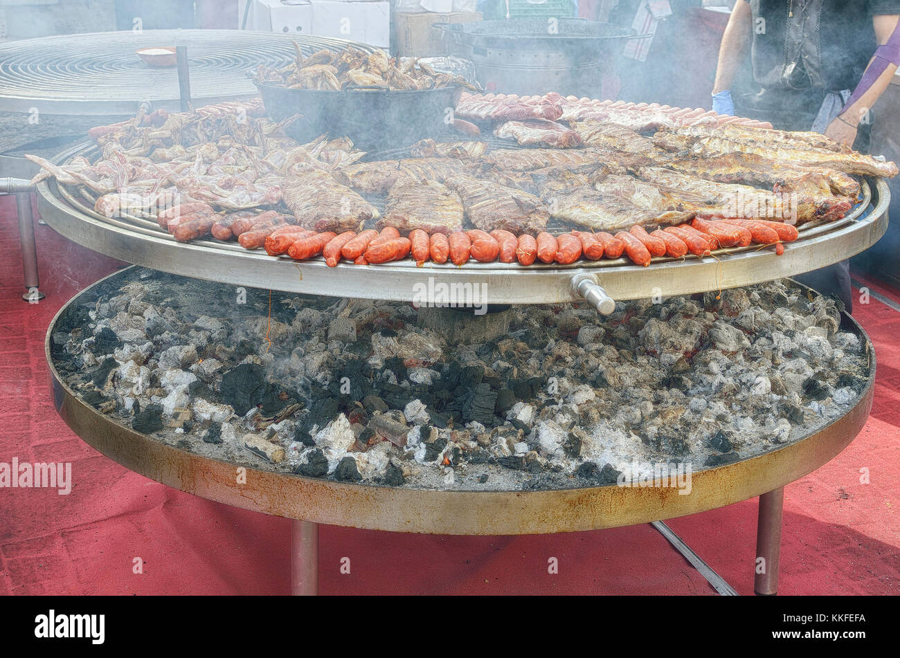 Cooking outdoors. Traditional food of Spain. Big barbecue grill of meat ...