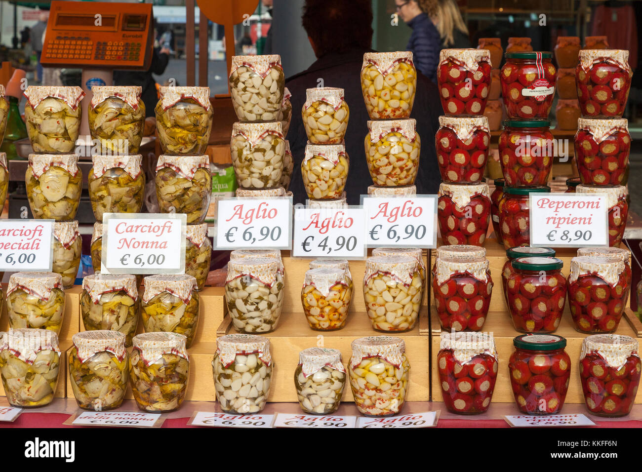 Display of speciality Italian potted vegetables in glass jars on ...