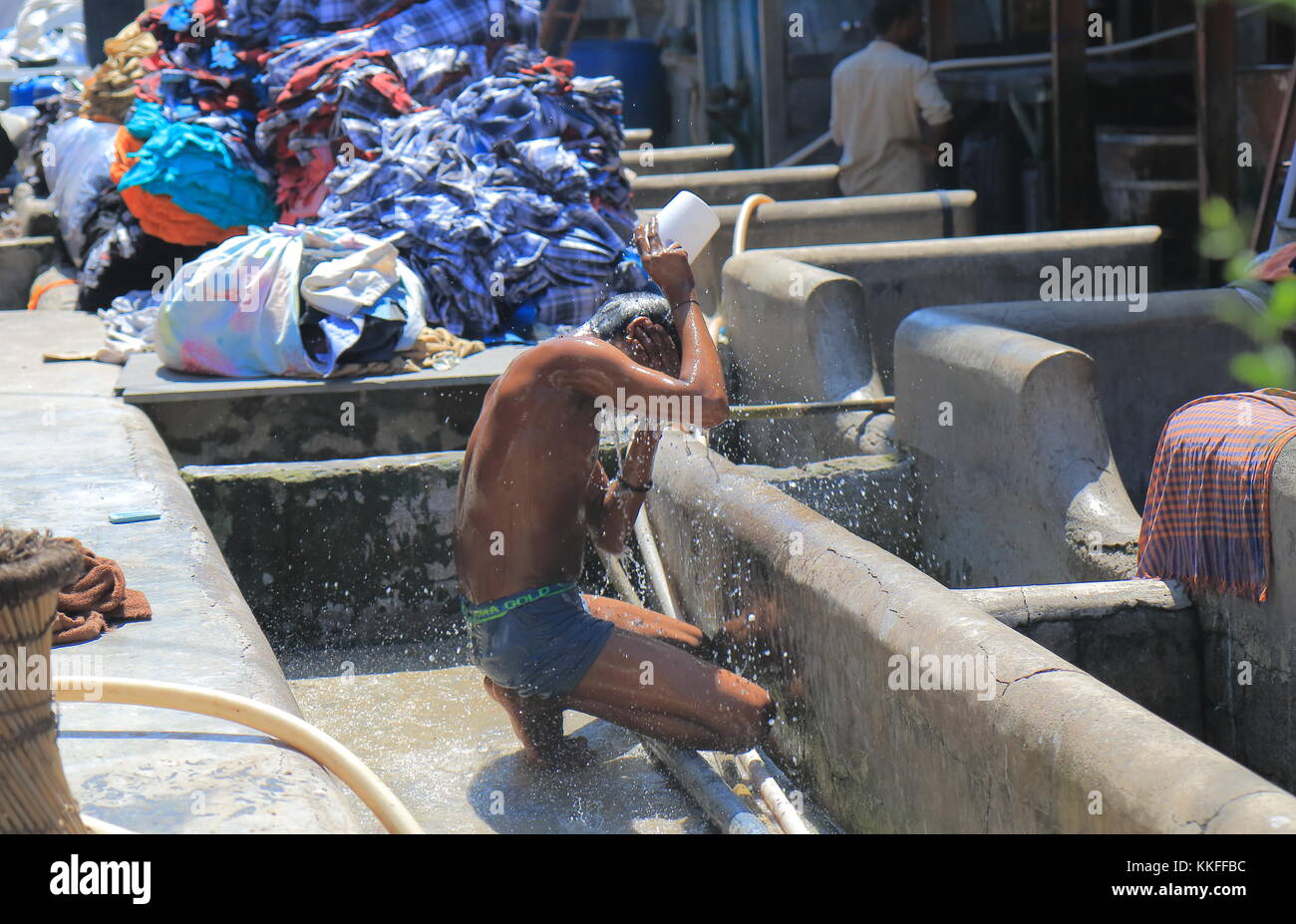 Indian man bathing washing clothes hi-res stock photography and images ...