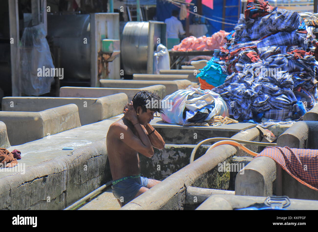 Indian man bathing washing clothes hi-res stock photography and images ...