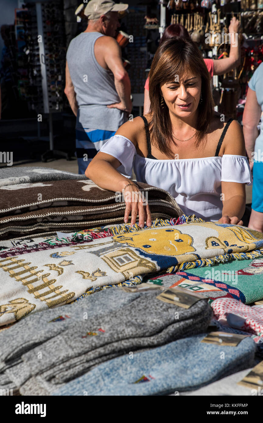 Lady selling rugs Stock Photo - Alamy