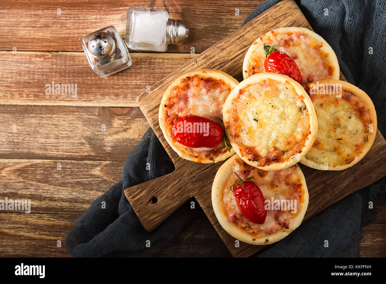 Italian homemade mini pizza with cheese, tomatoes. Dark background ...