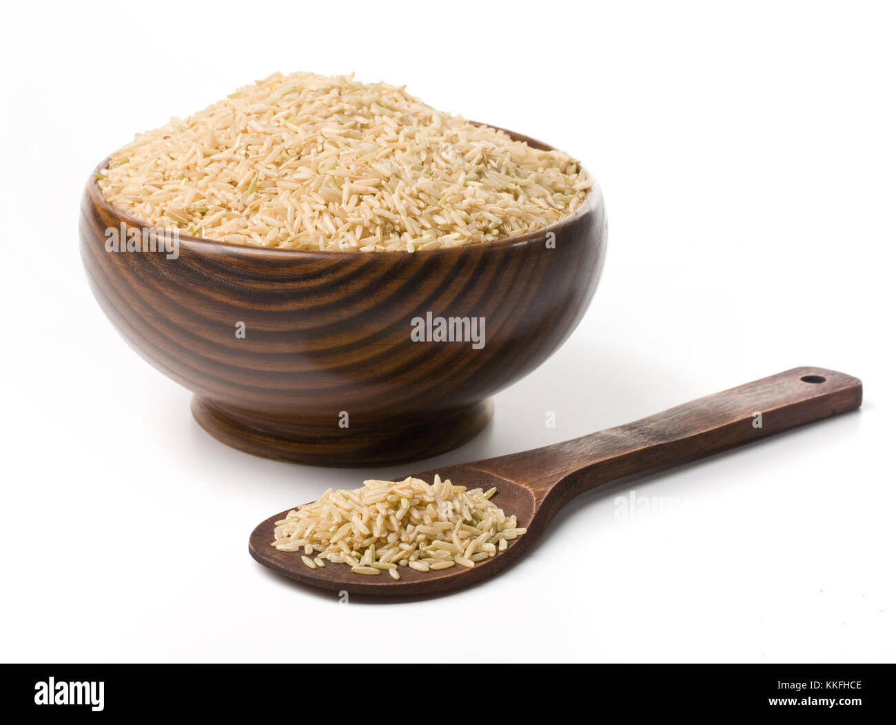 wooden cup with uncooked rice on a white background Stock Photo - Alamy