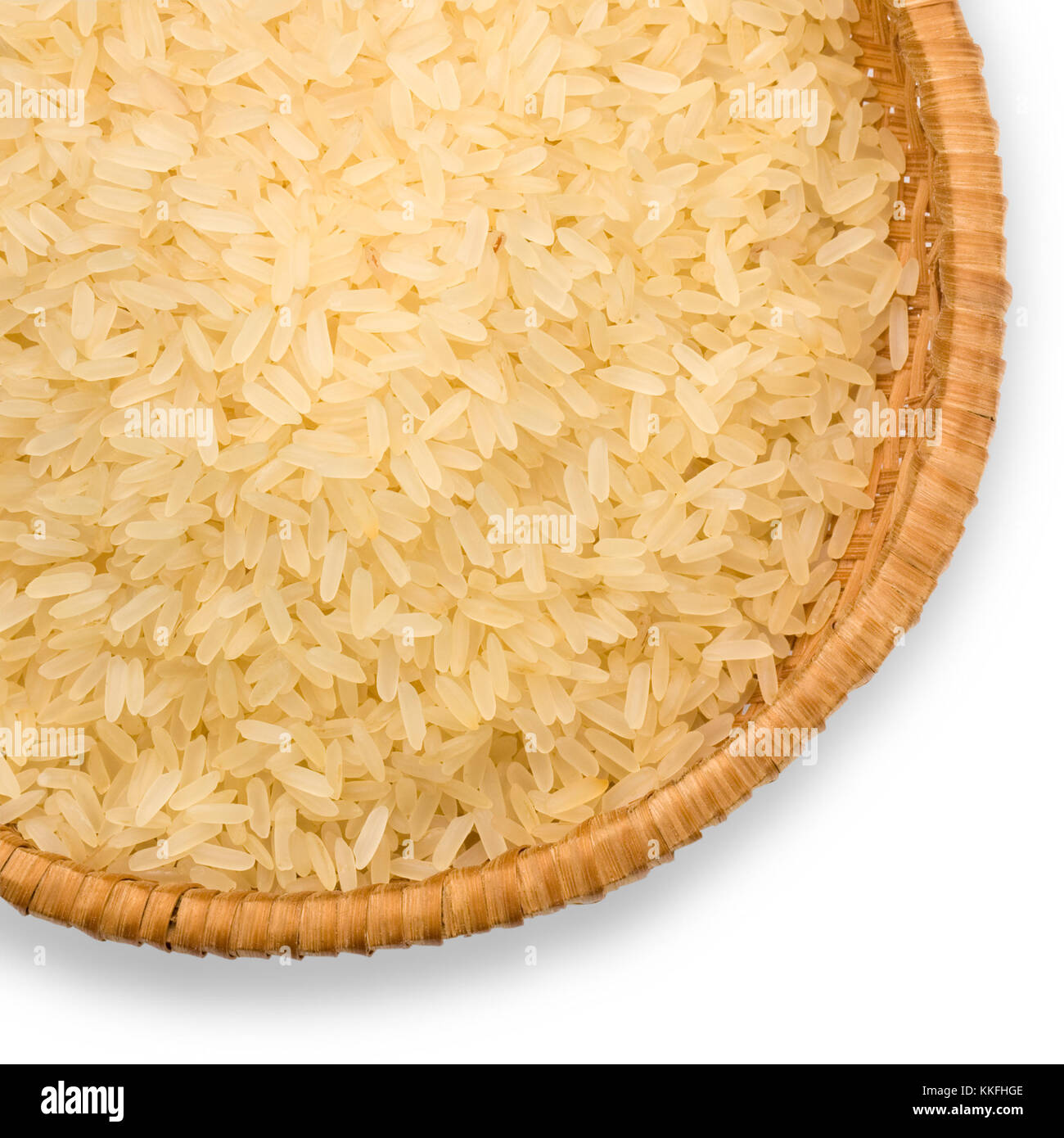 straw plate of long grain rice on a white background Stock Photo - Alamy