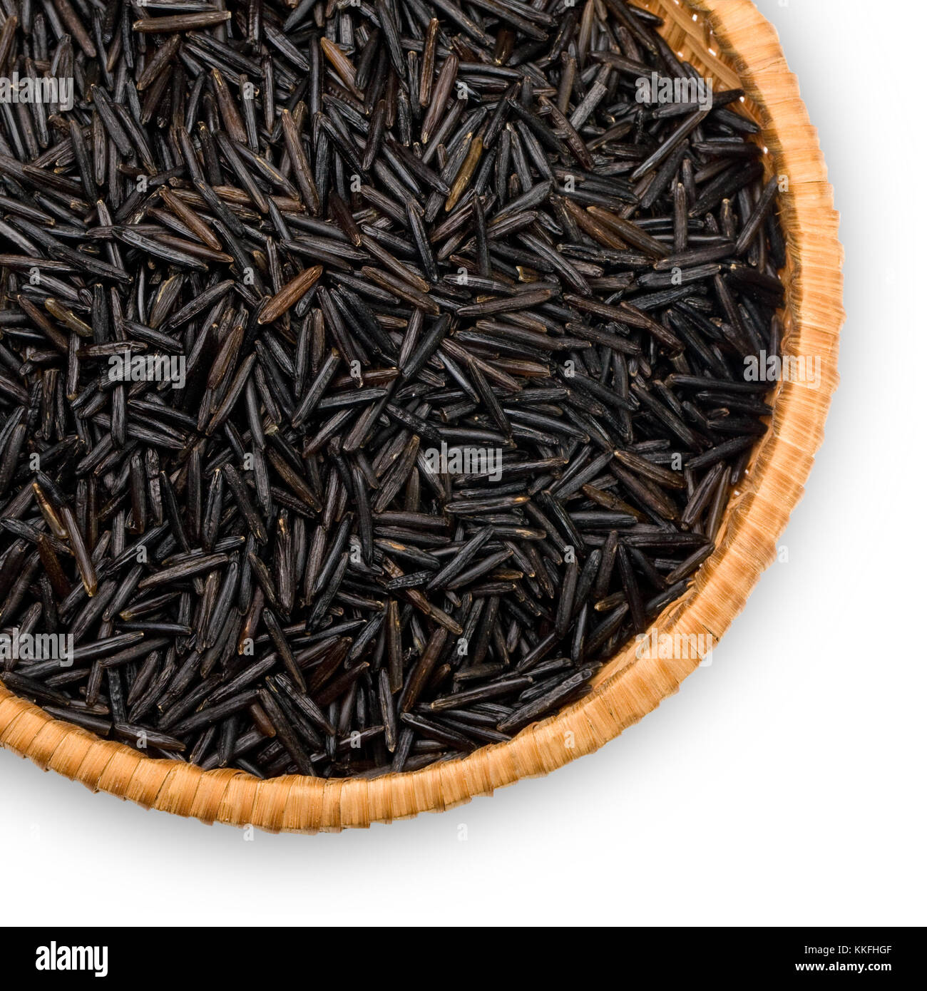 straw plate with wild black rice on a white background Stock Photo - Alamy