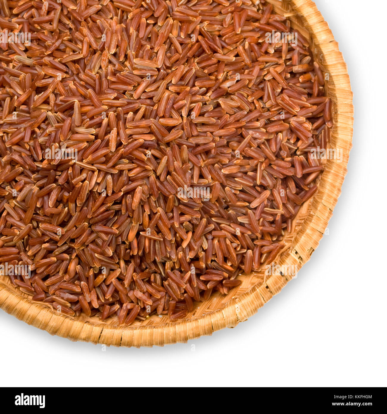 straw plate with long-grain red rice on white background Stock Photo ...