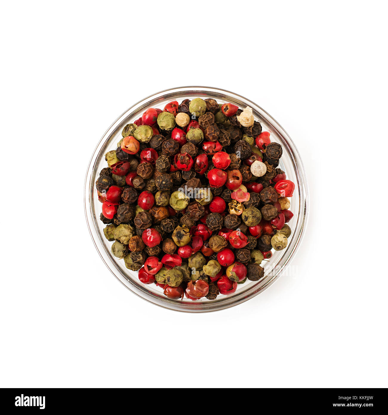 Mix of pepper in a bowl isolated on a white background Stock Photo - Alamy