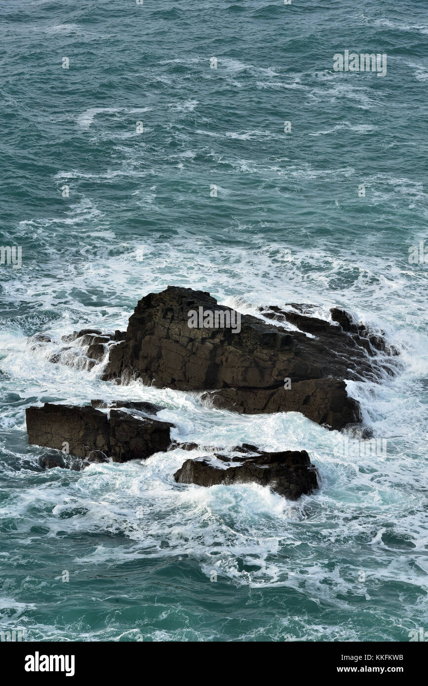 Some jagged rocks on the north cornish coast sticking out of the water ...