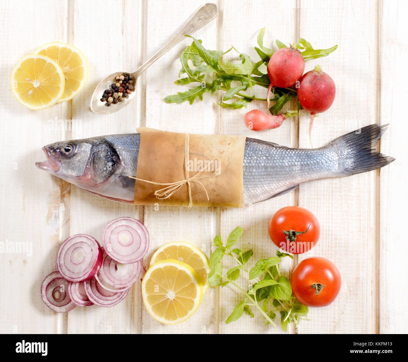 Bass fish from above on the white wooden background Stock Photo - Alamy