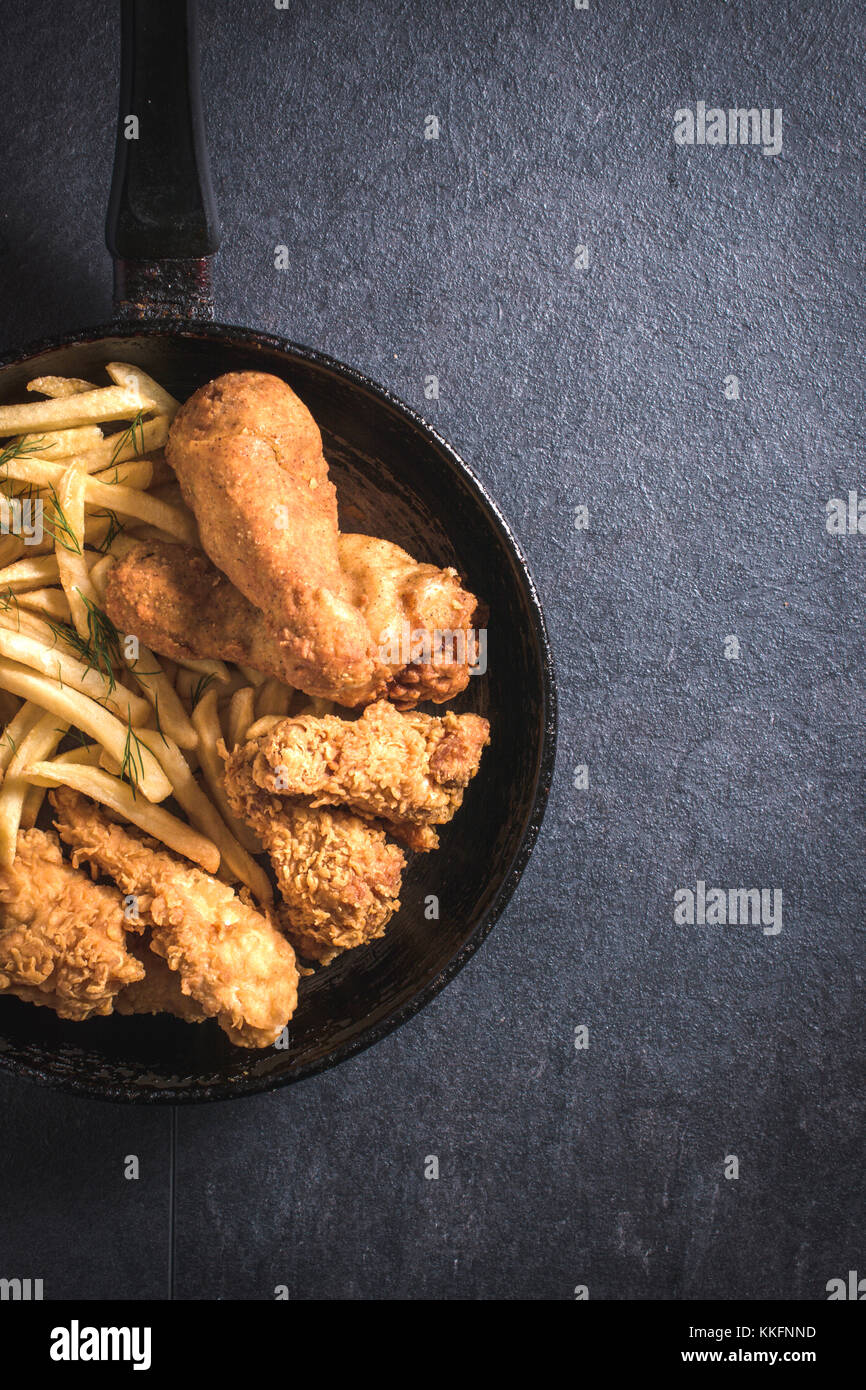 Fried chicken and French fries in the pan from above,blank space Stock ...