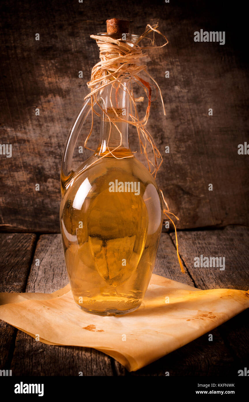 Glass bottle of Serbian traditional drink Rakia on the wooden table ...