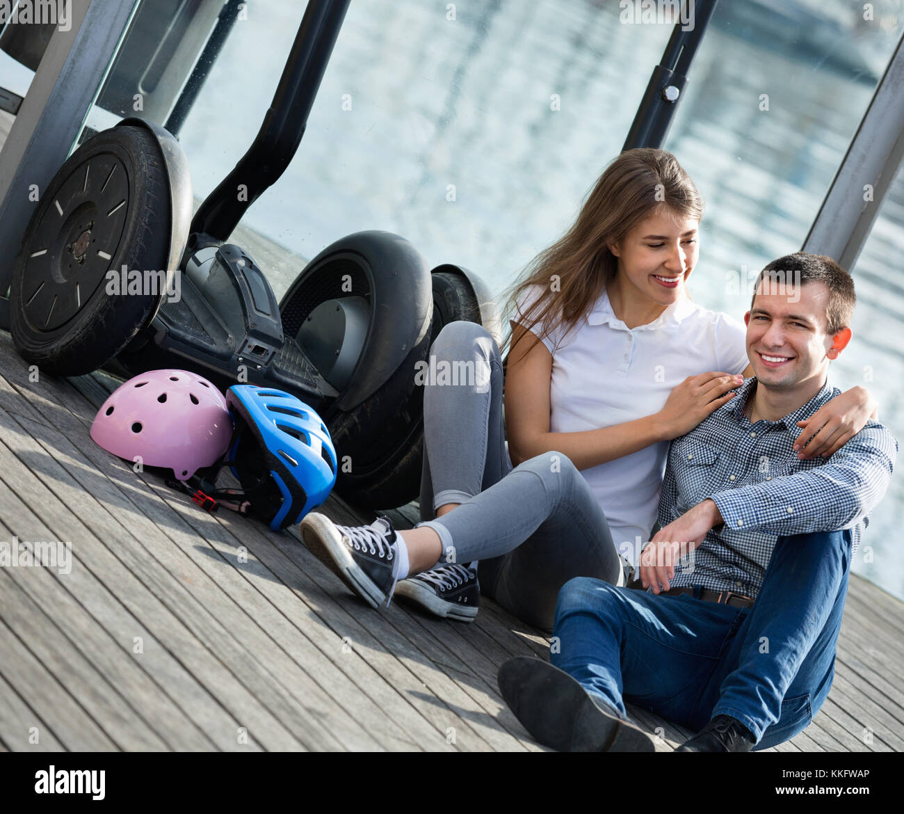 Positive cheerful smiling tourists couple relaxing near segways on ...