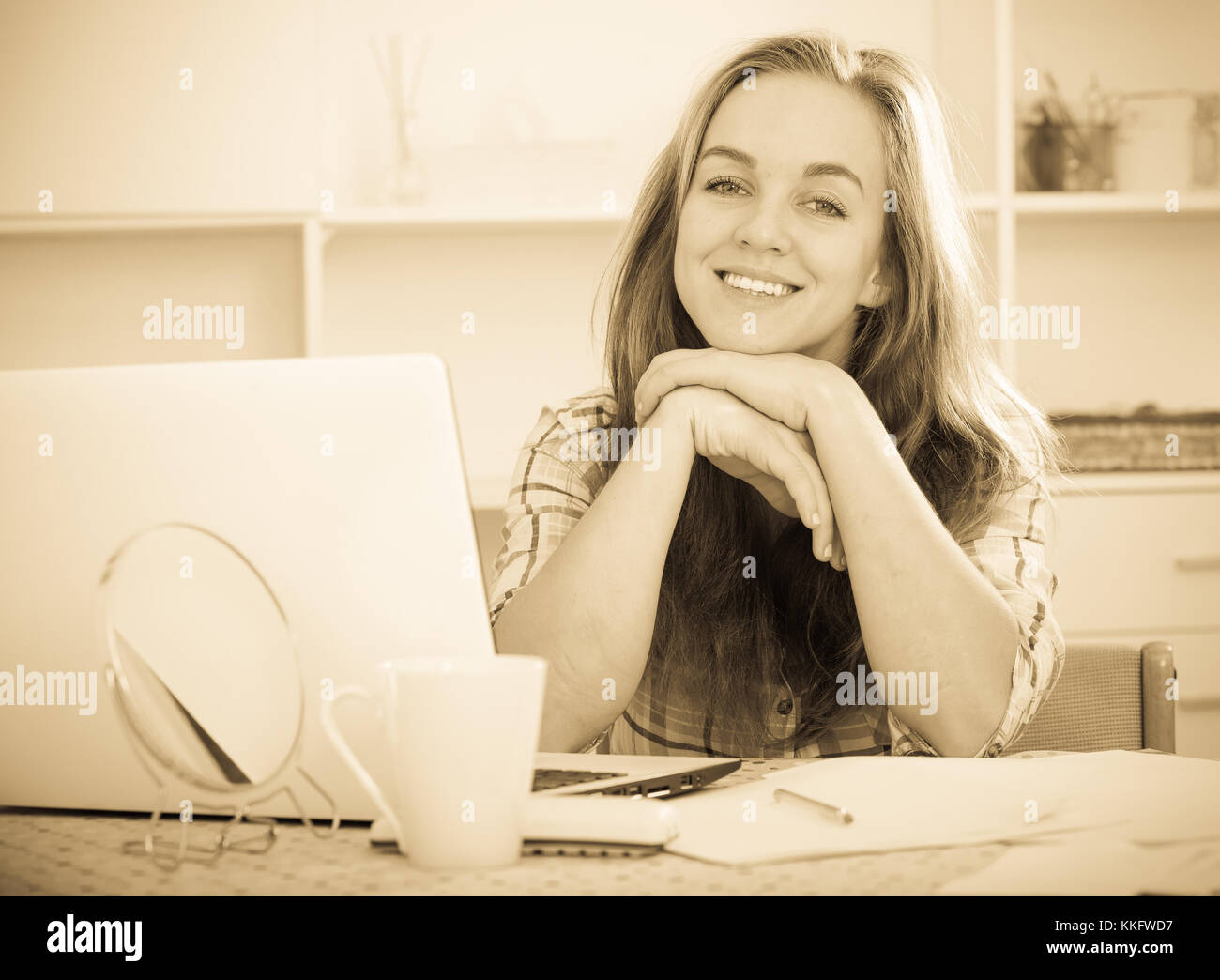 girl working on laptop at room table Stock Photo - Alamy